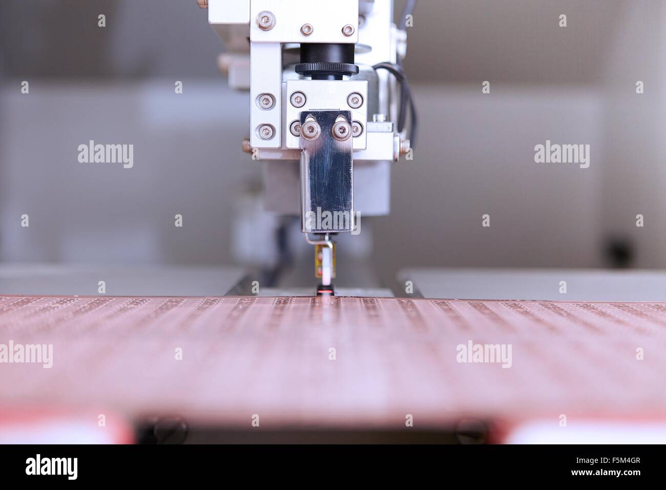 Close up of cutting machine cutting flexible circuits Stock Photo - Alamy