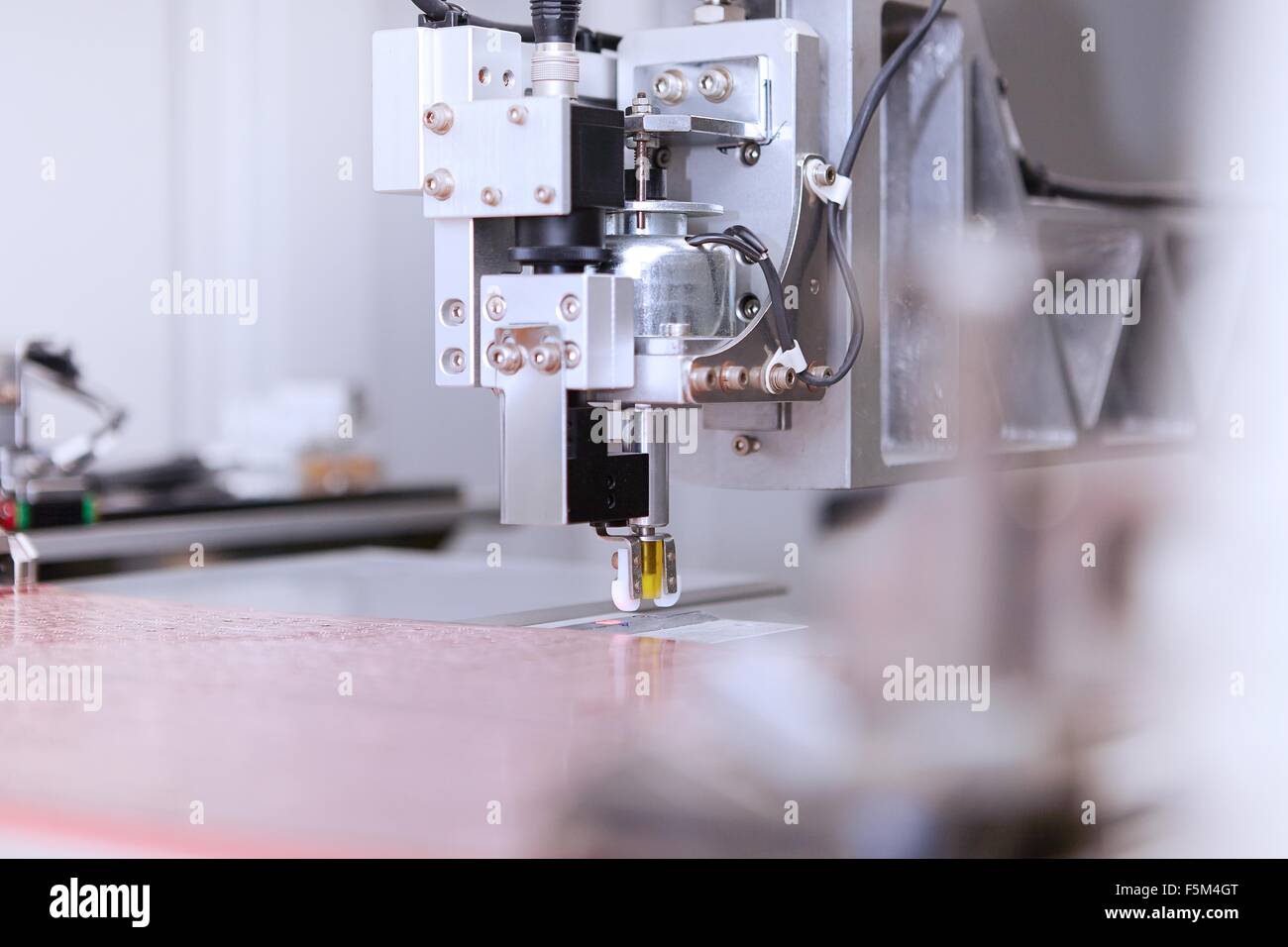 Close up of cutting machine cutting flexible circuits Stock Photo - Alamy