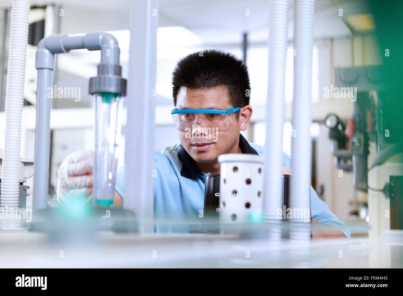 Man wearing safety goggles in flexible electronics plant Stock Photo ...