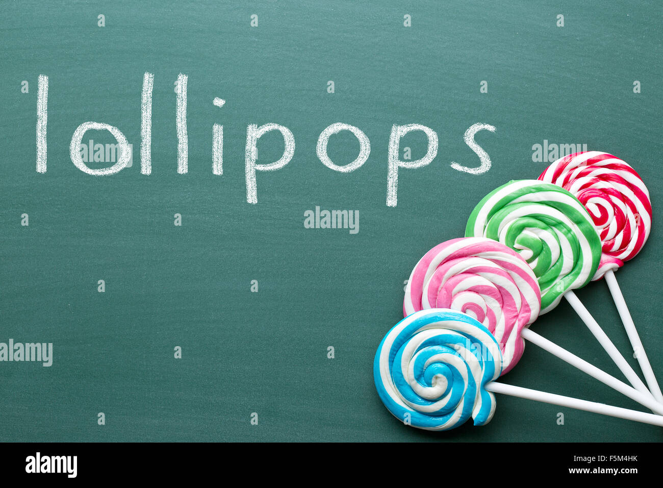 colorful swirl lollipop on chalkboard Stock Photo - Alamy