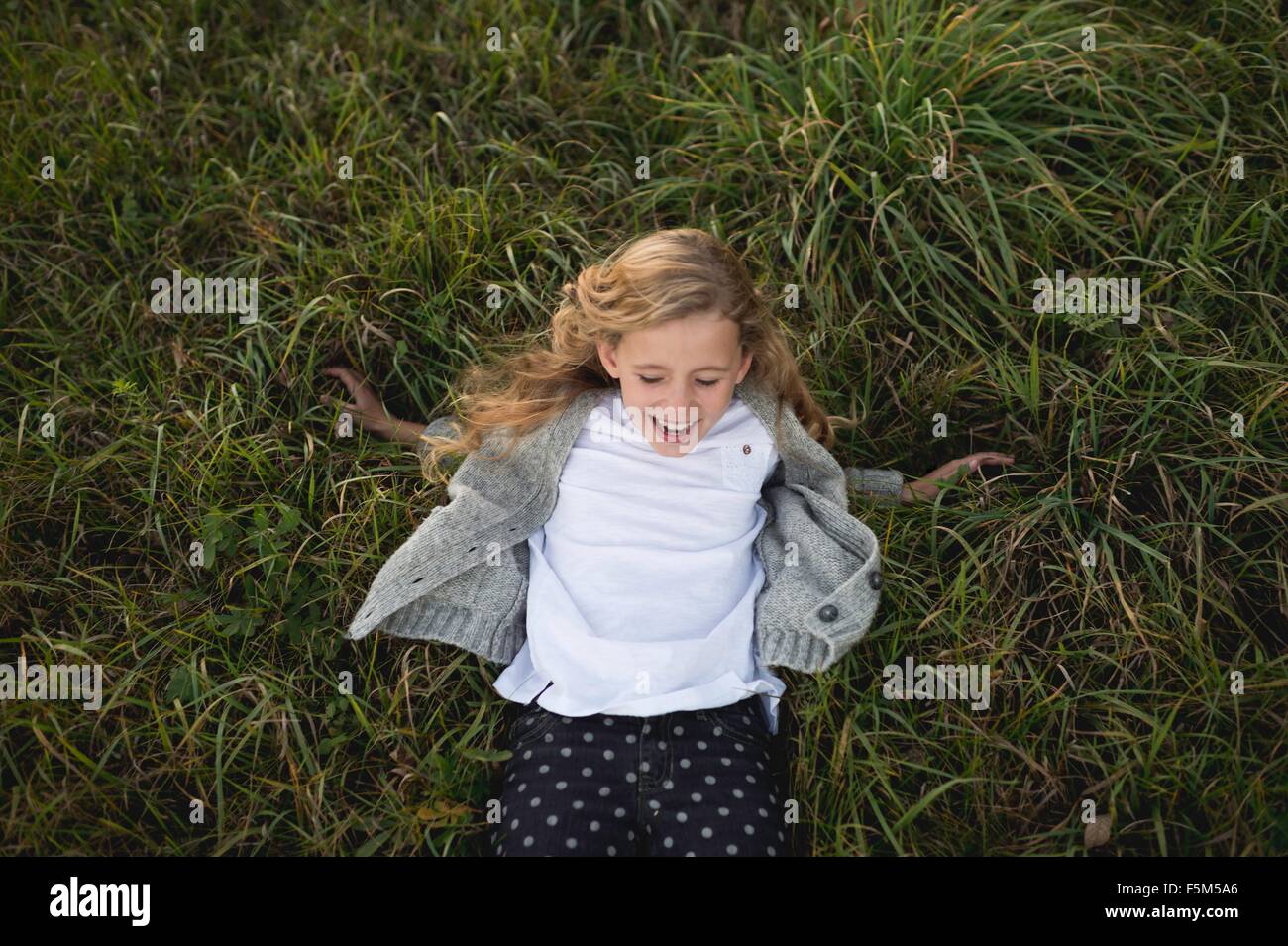 Young girl playing on grass, overhead view Stock Photo - Alamy