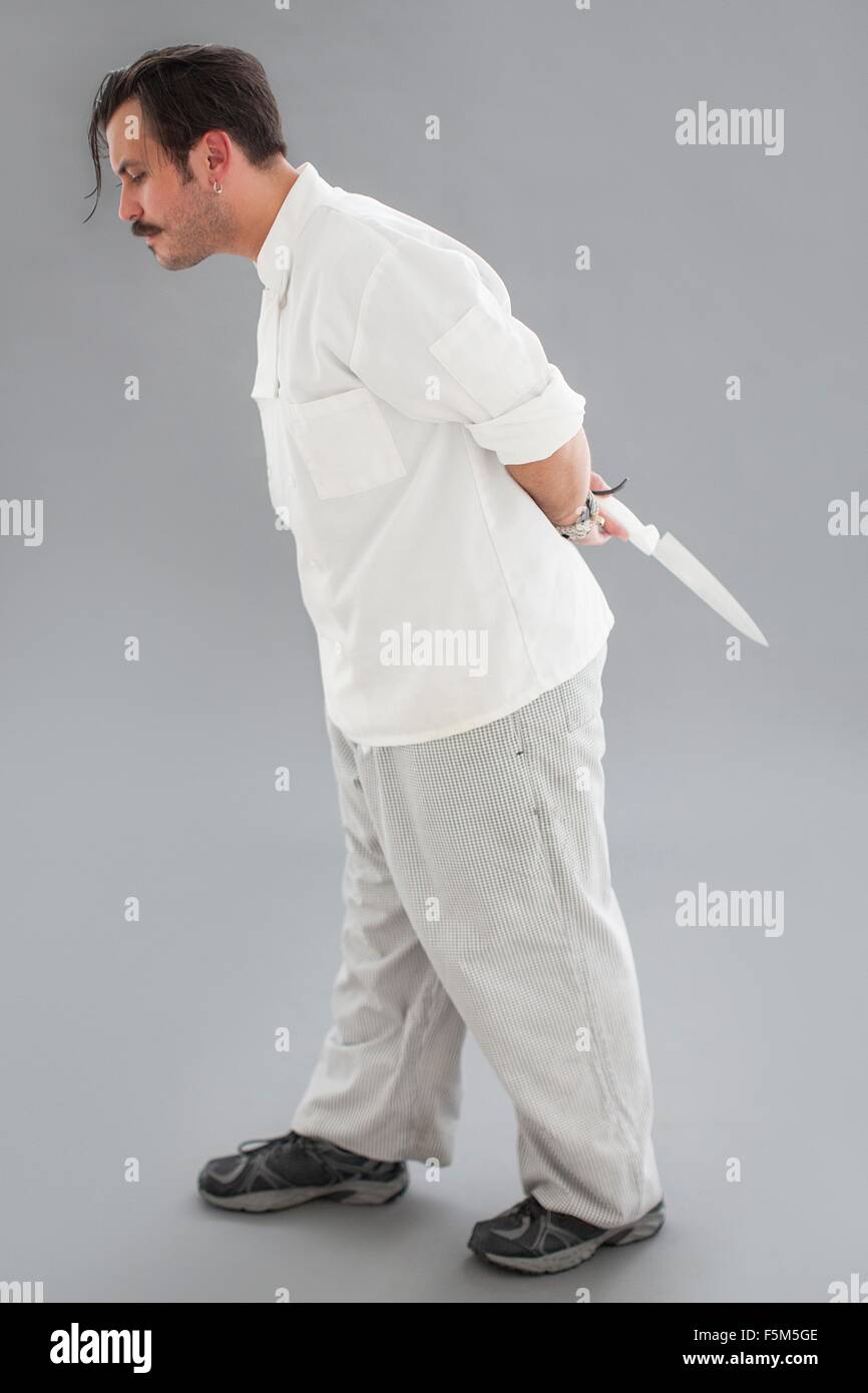 Man knife behind back hi-res stock photography and images - Alamy