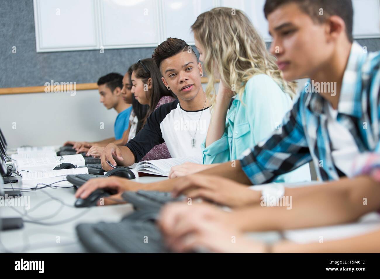 Row of high school students concentrating in computer class Stock Photo ...