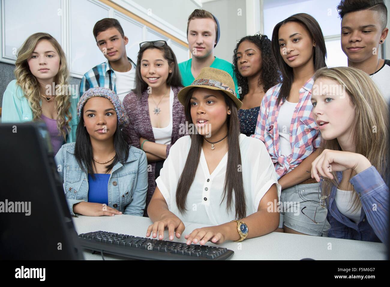 Group of teenagers working on computer in high school class Stock Photo ...