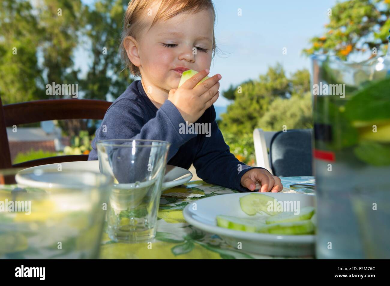 Child eating fruit table hi-res stock photography and images - Alamy