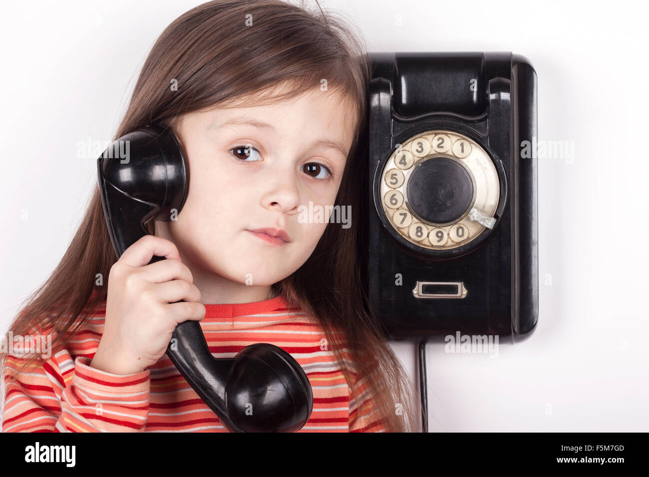 Serious child talking on phone isolated, white background Stock Photo ...