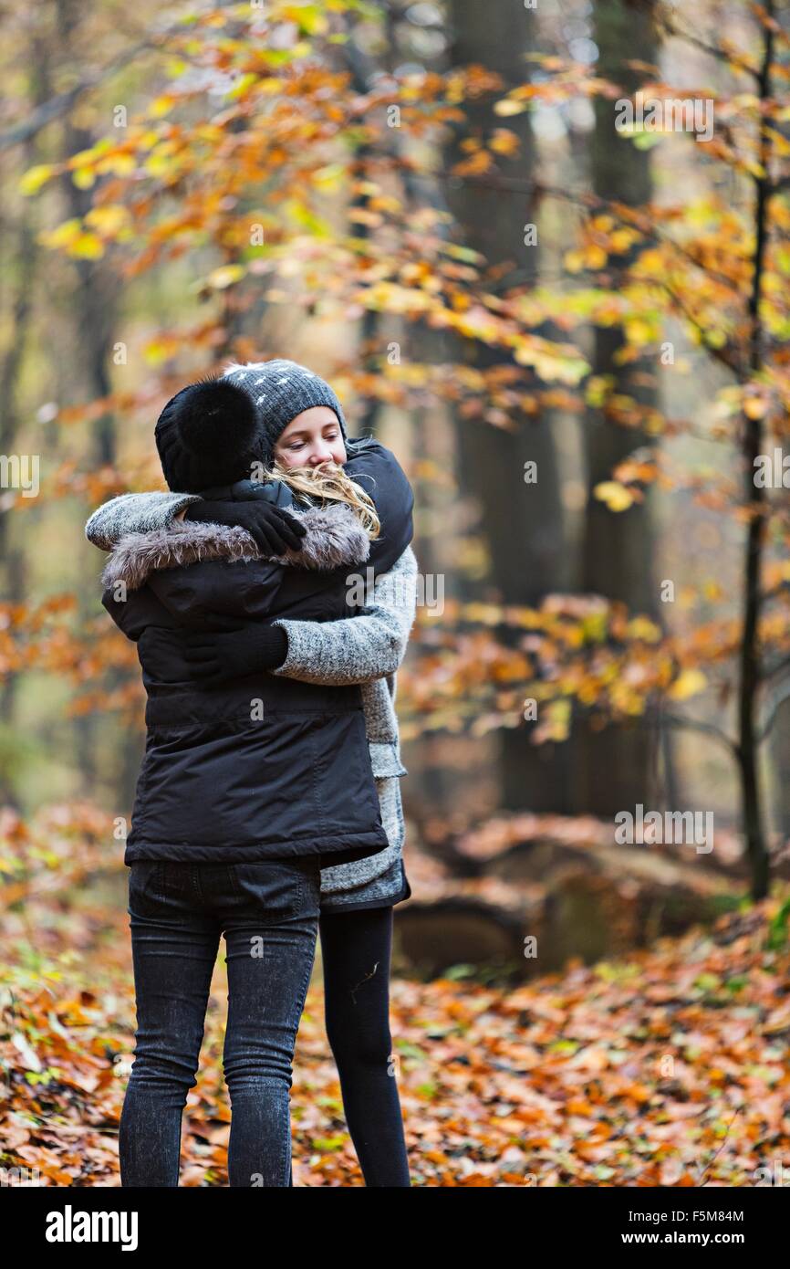 Two girls hugging tree hi-res stock photography and images - Alamy