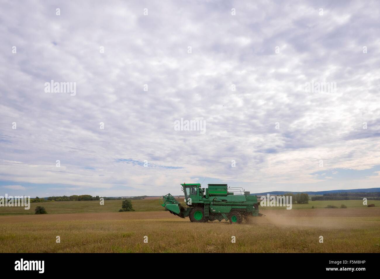 Combine harvester in field Stock Photo - Alamy
