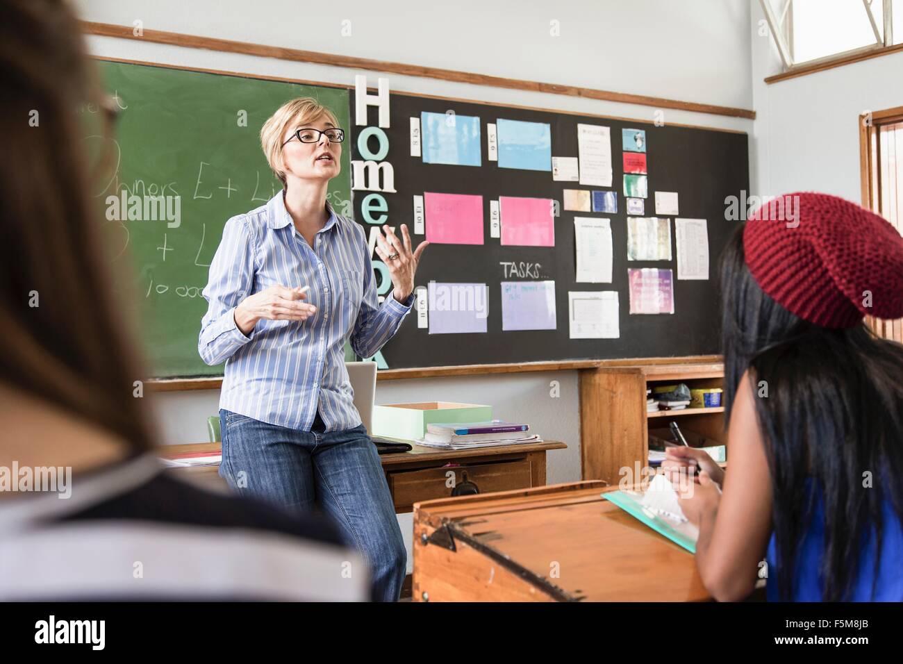 Female teacher addressing students in classroom Stock Photo - Alamy