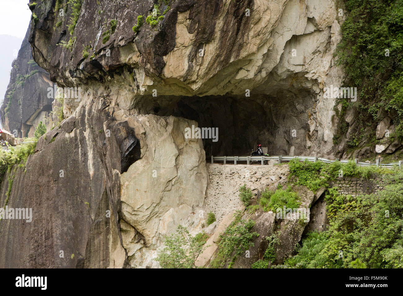 India, Himachal Pradesh, Kinnaur, road tunnel cut in rock overhang of ...