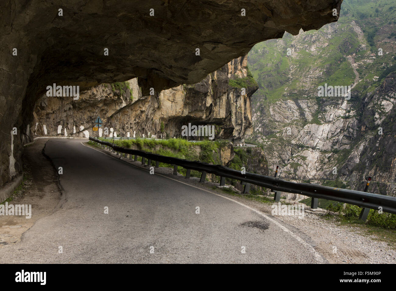 India, Himachal Pradesh, Kinnaur, road cut in rock overhang of River ...