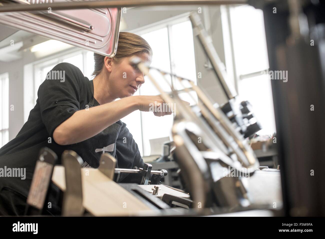 Female printer preparing machine in workshop Stock Photo - Alamy