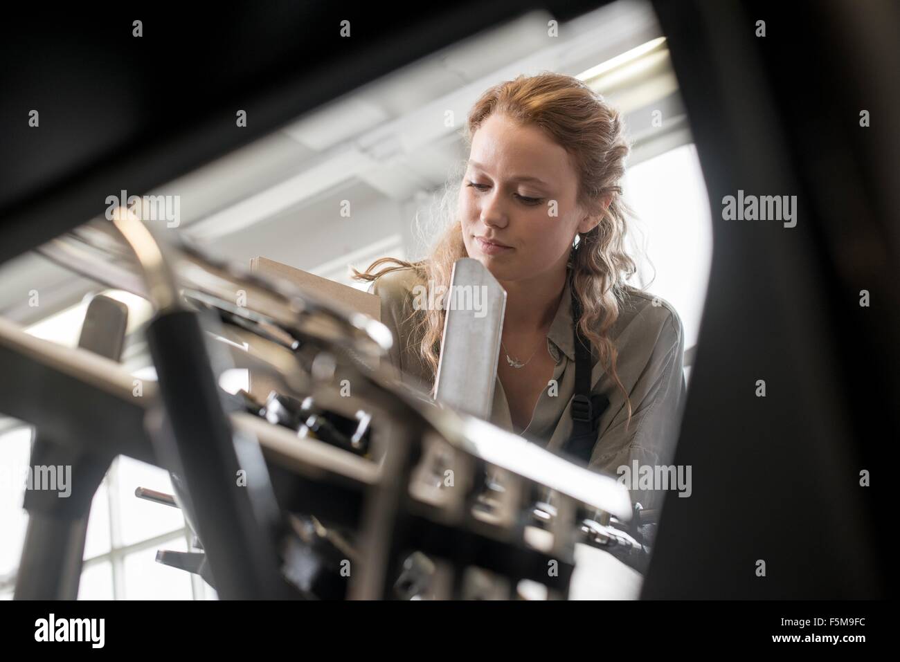 Female printer preparing paper for machine in workshop Stock Photo - Alamy