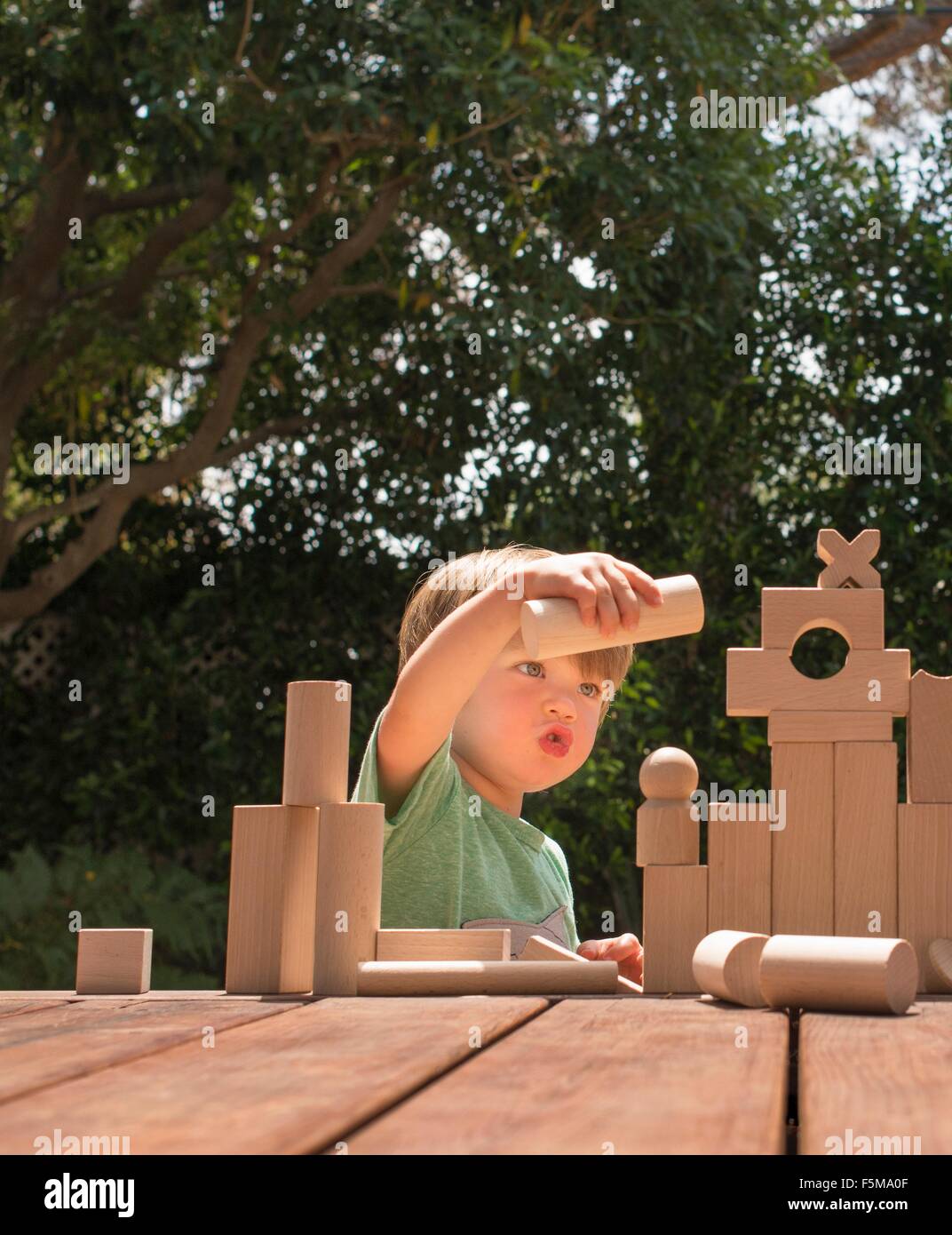 Boy playing with wooden blocks hi-res stock photography and images - Alamy