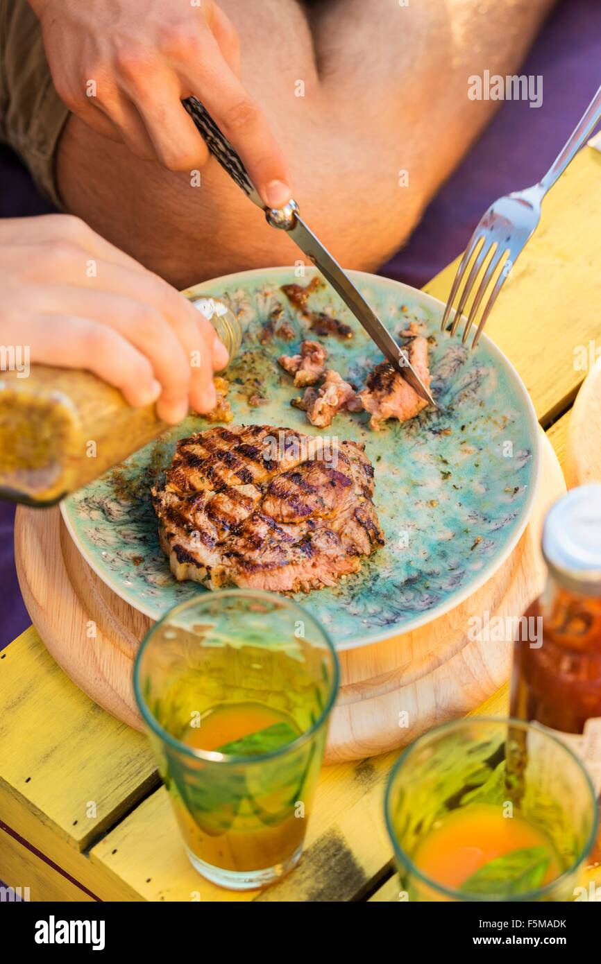 Man cutting meat hi-res stock photography and images - Alamy
