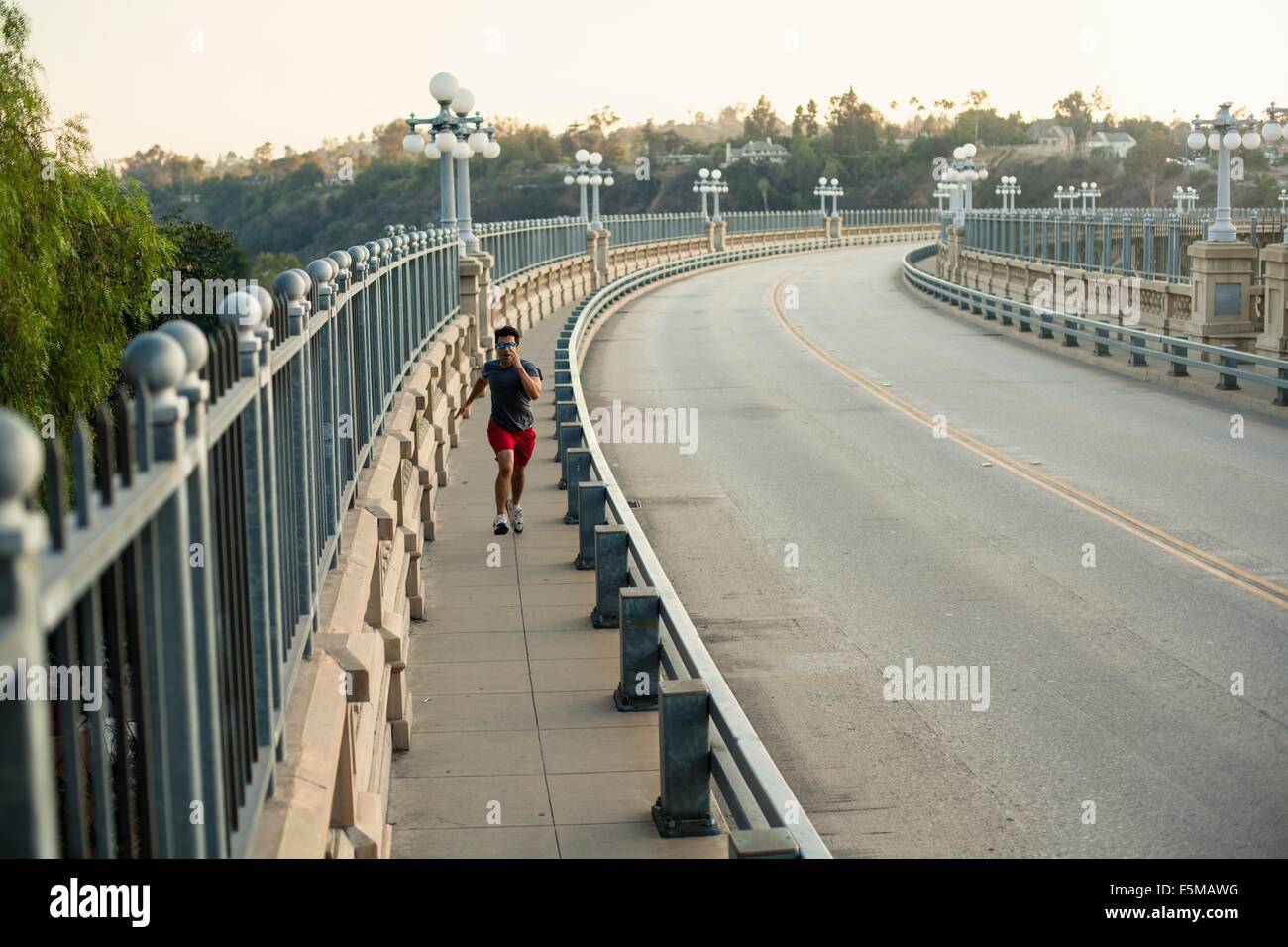 Jogger running on bridge, Arroyo Seco Park, Pasadena, California, USA ...
