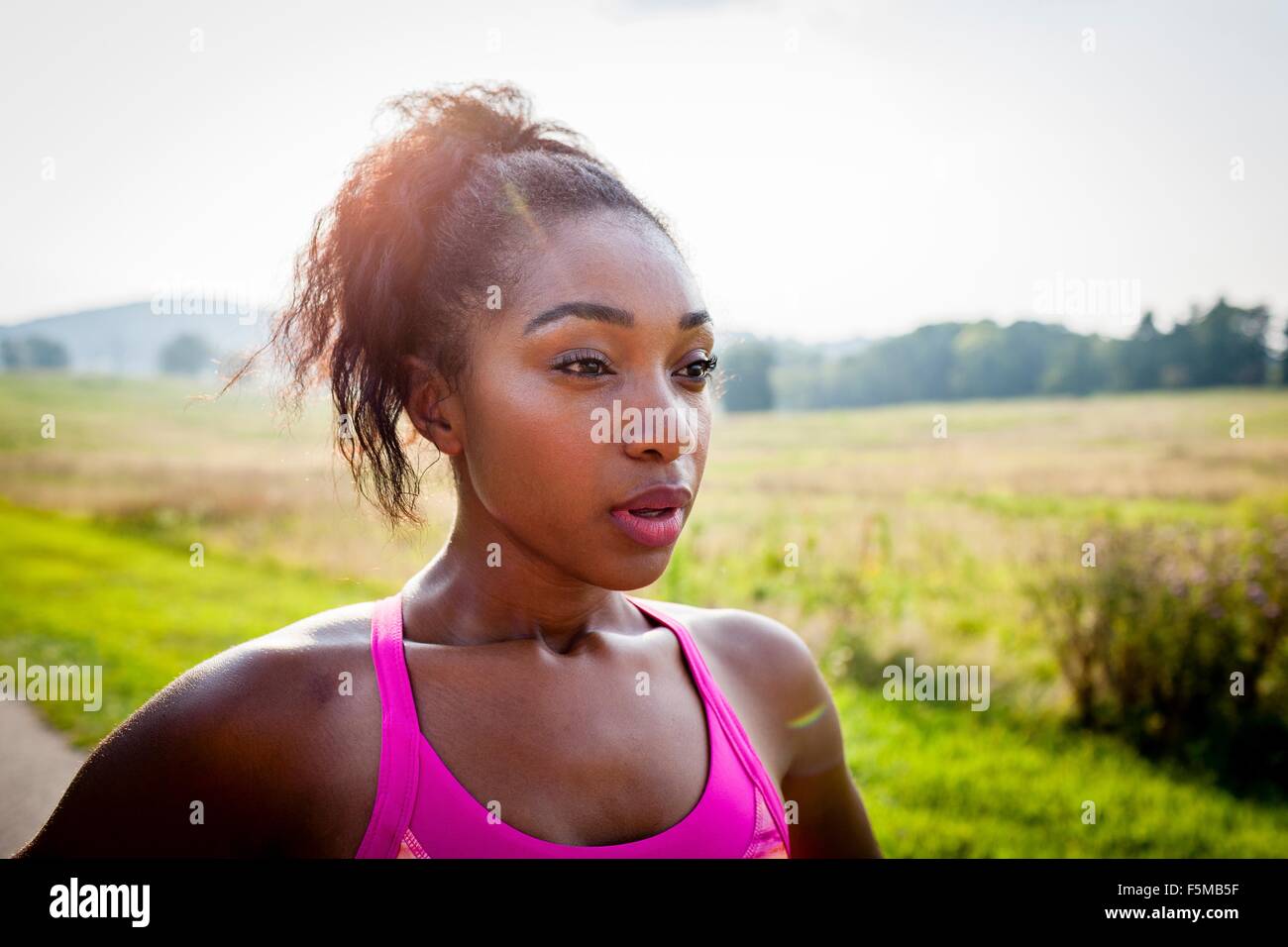 Confident young female runner in rural park Stock Photo - Alamy