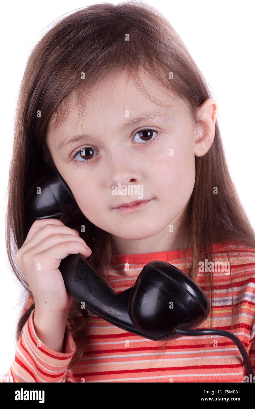 Serious sad child talking on phone, white background Stock Photo - Alamy