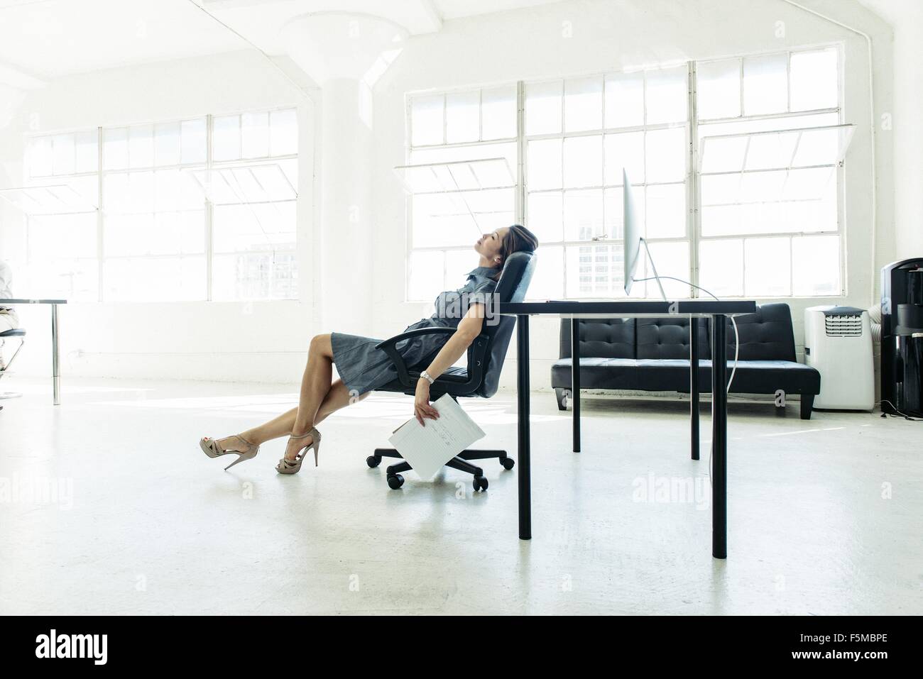 Woman sitting on chair exhausted hi-res stock photography and images ...