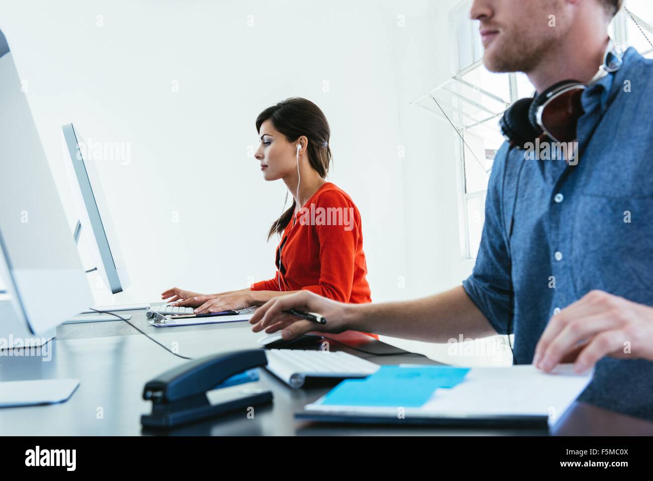 Business people working on computer by office window Stock Photo - Alamy
