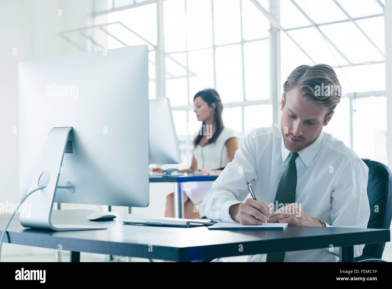 Business people working on computer by office window Stock Photo - Alamy