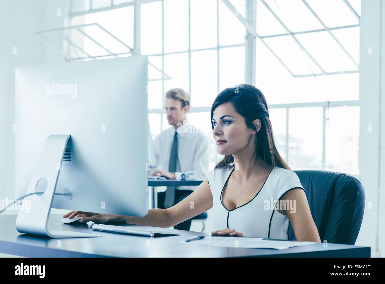 Business people working on computer by office window Stock Photo - Alamy