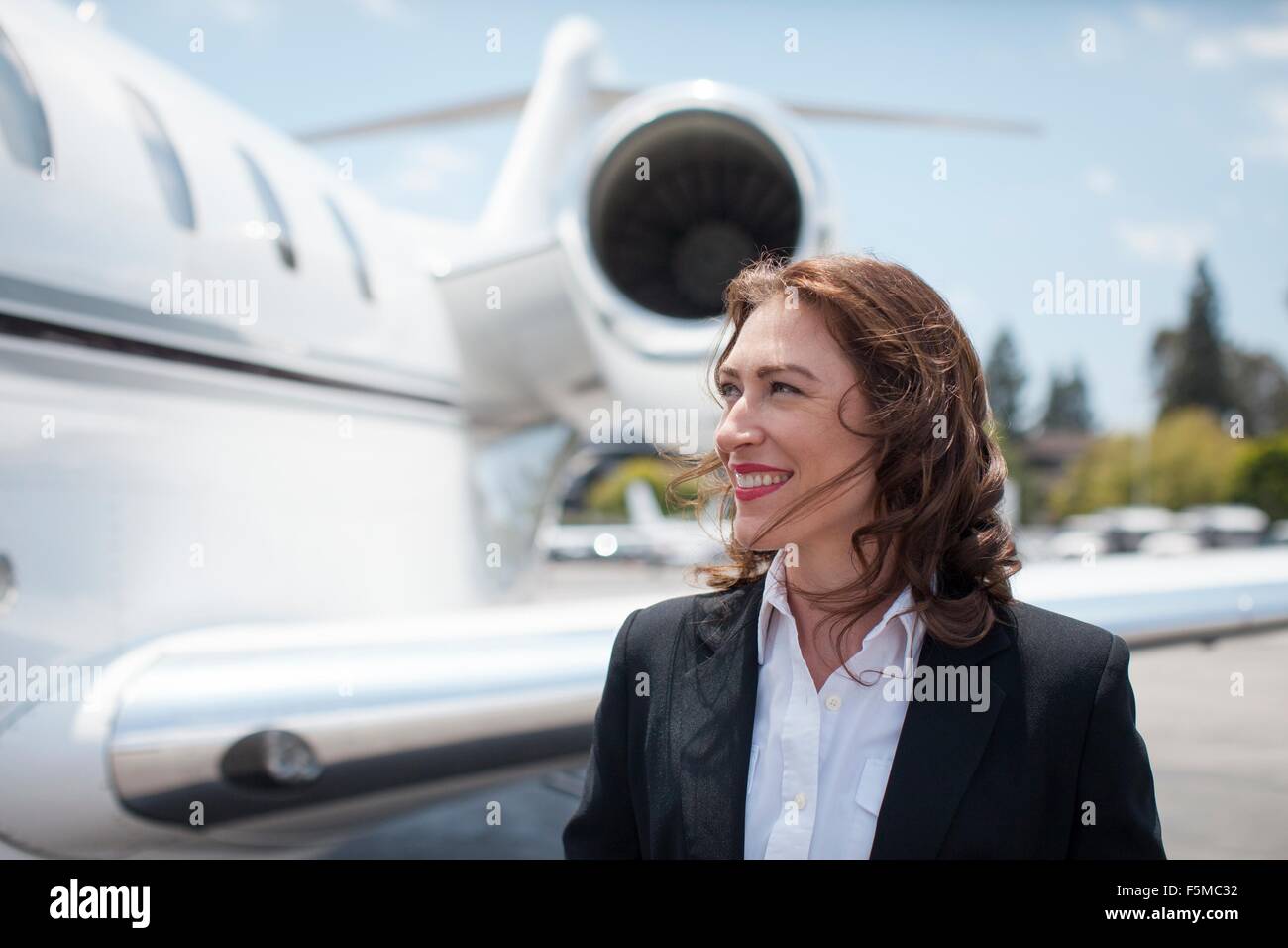 Mid adult female businesswoman and private jet at airport Stock Photo ...