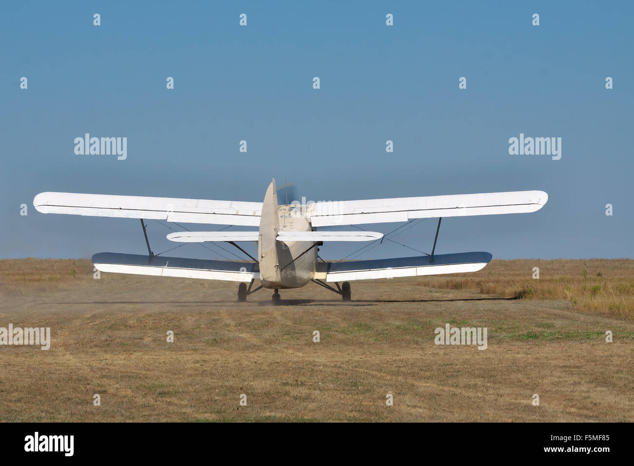 Old biplane taxiing to the runway on the airfield Stock Photo - Alamy