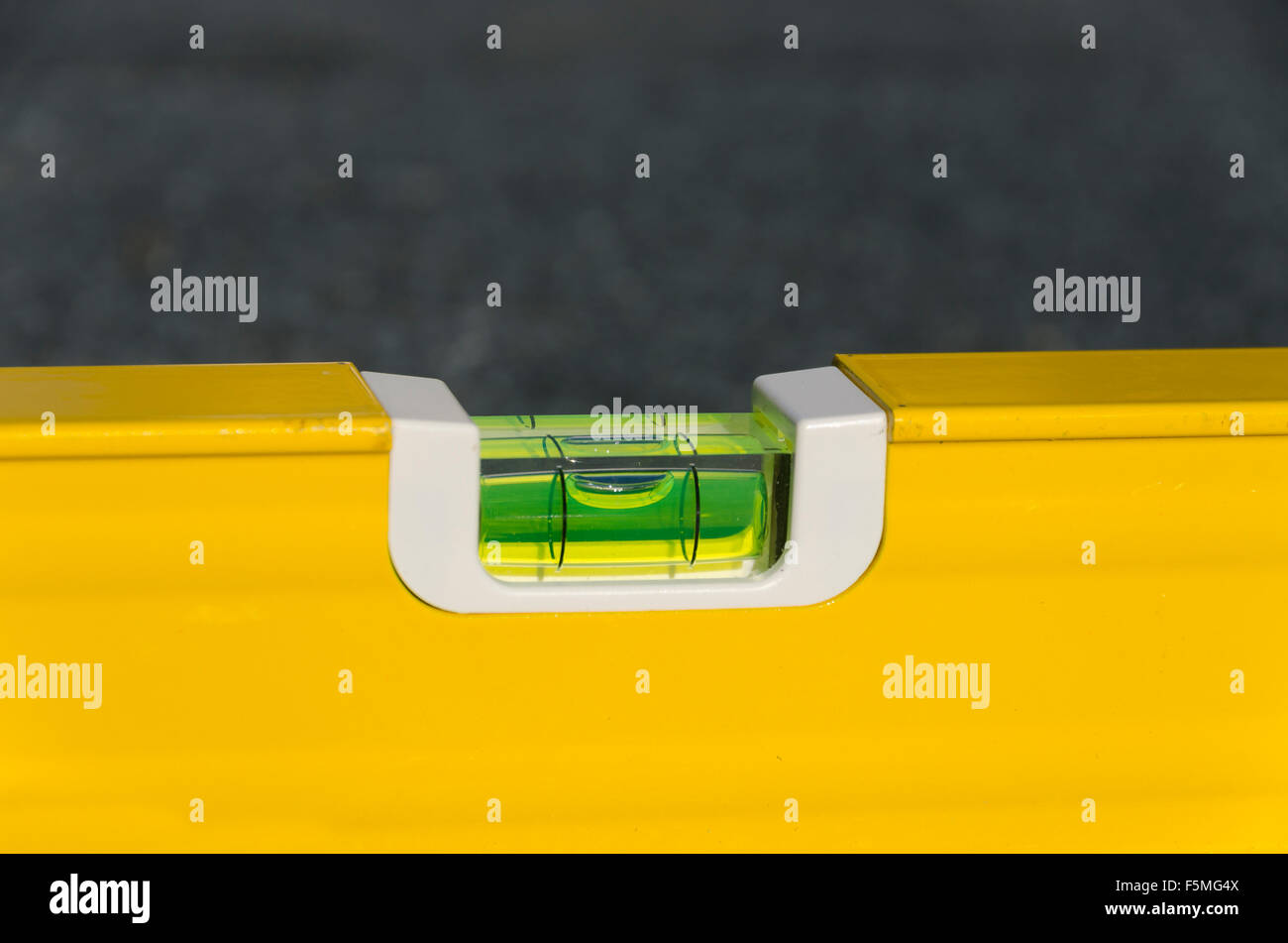 Yellow spirit level on a roof Stock Photo - Alamy