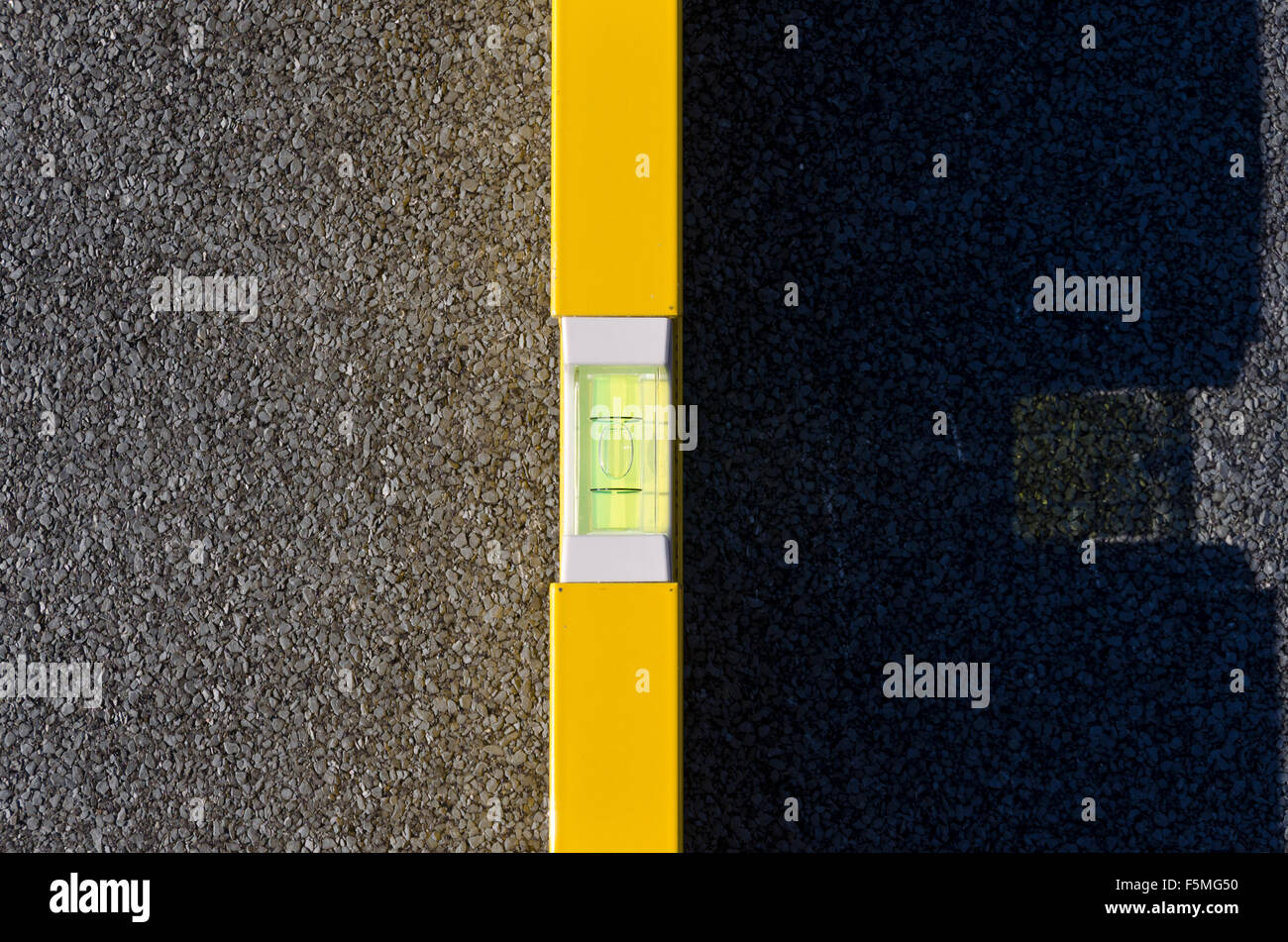 Yellow spirit level on a roof Stock Photo - Alamy
