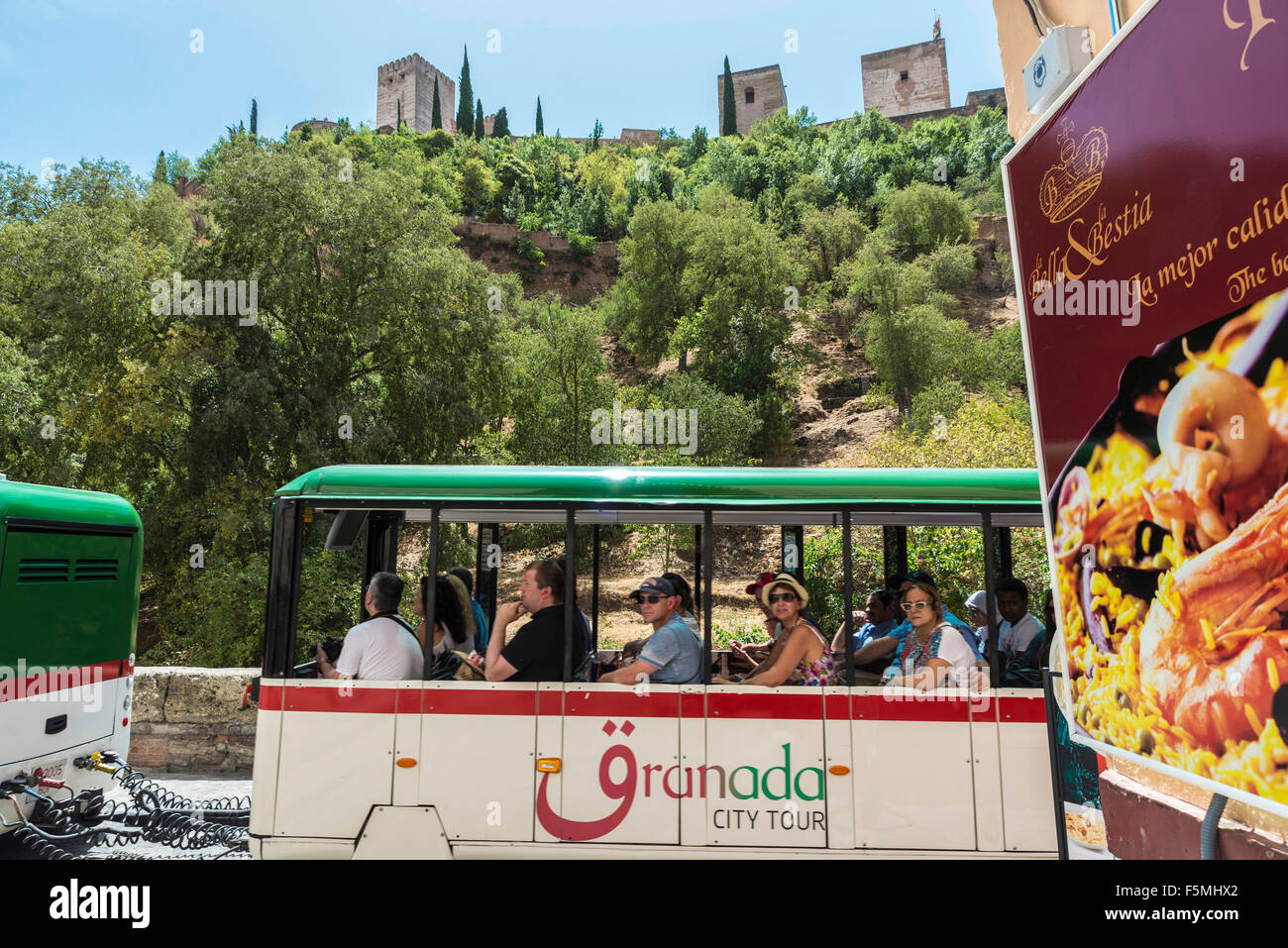 Tourist bus in the old town of Granada, near the Darro river, Andalusia ...