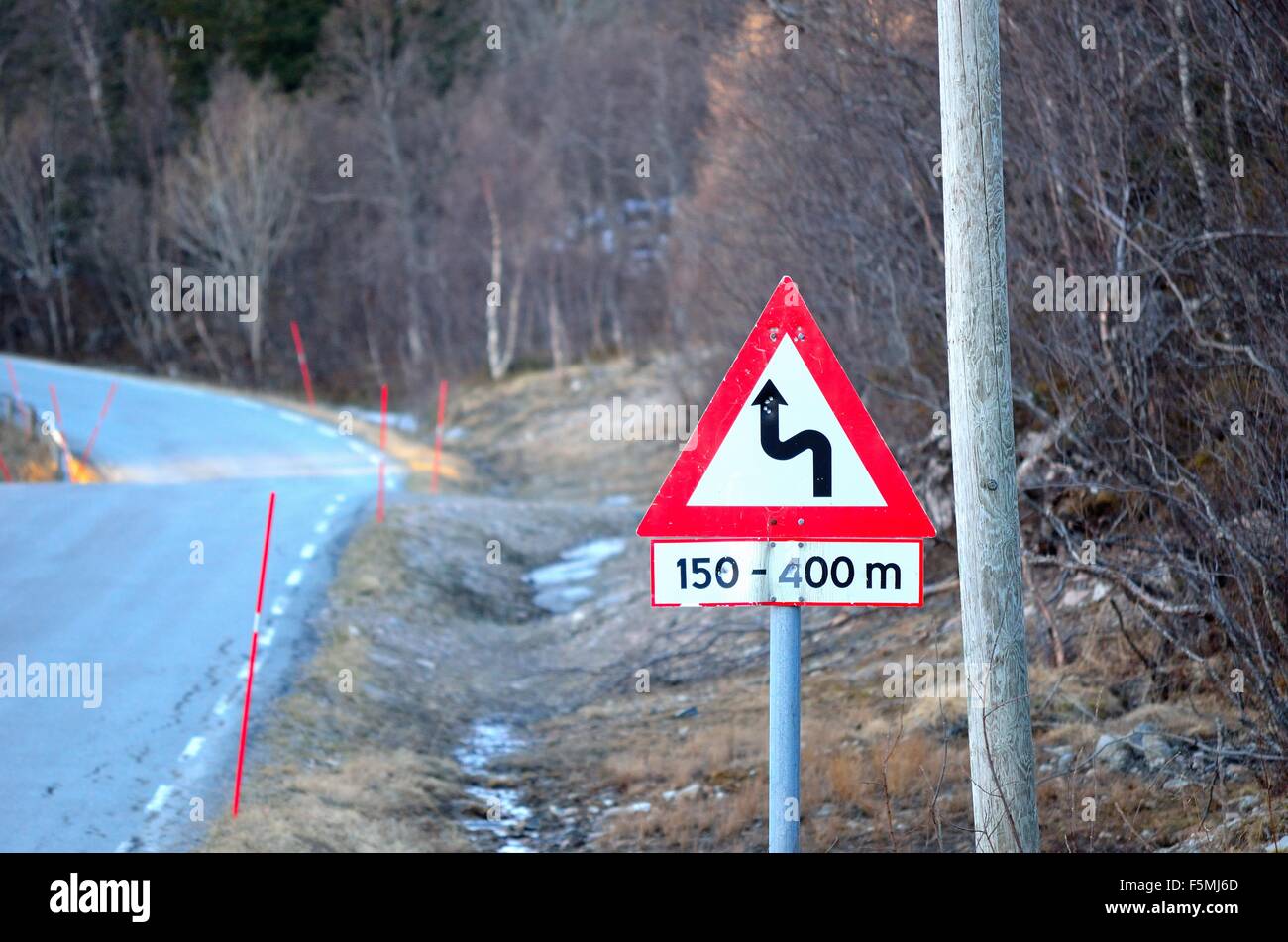 twisted road ahead warning sign in norway Stock Photo - Alamy