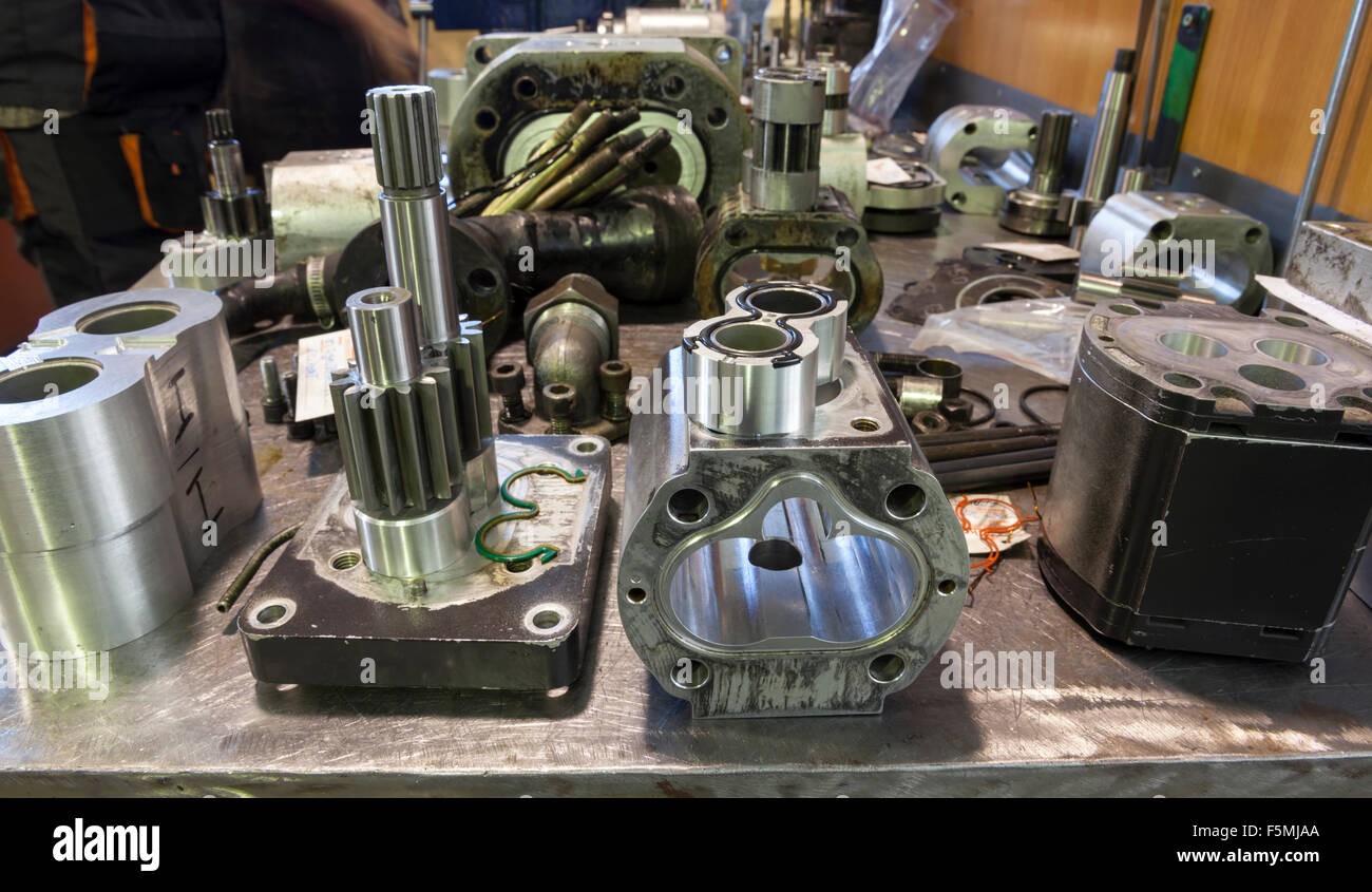hydraulic engine parts on the work table Stock Photo - Alamy