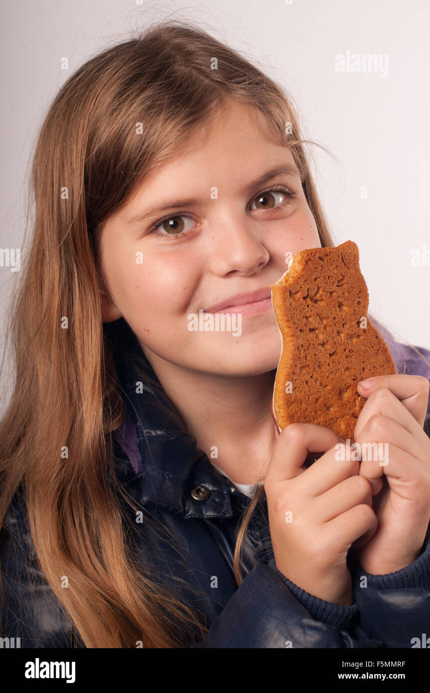 Girl with cookie portrait, she likes it very much Stock Photo - Alamy