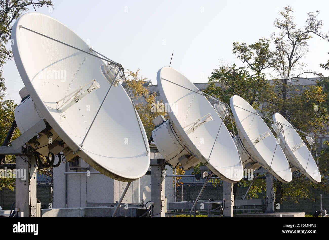 Four high power satellite antennae facing the sky Stock Photo - Alamy