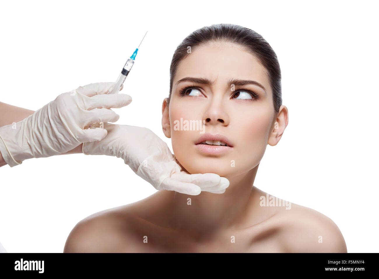 Scared girl looking at syringe Stock Photo - Alamy