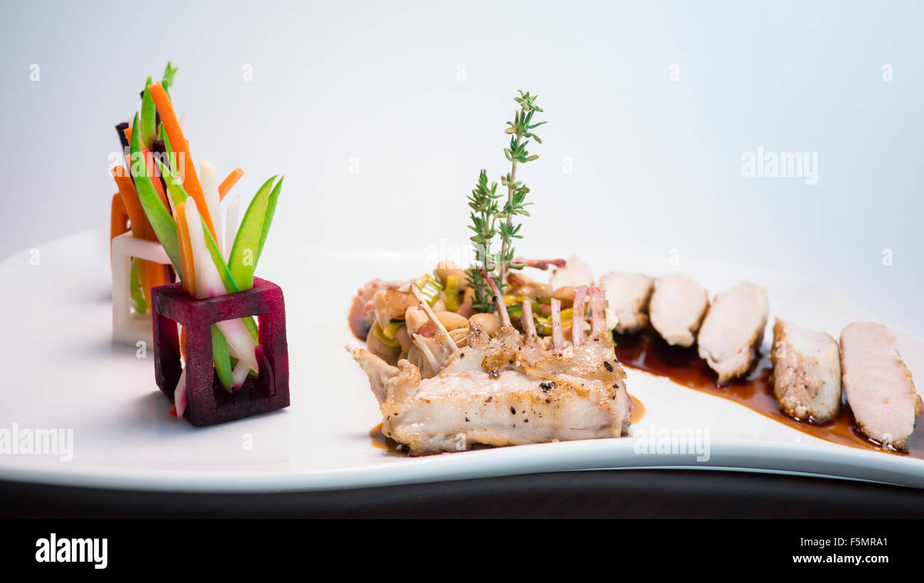 Sauteed rabbit loin and chops with bean medley and vegetables Stock ...