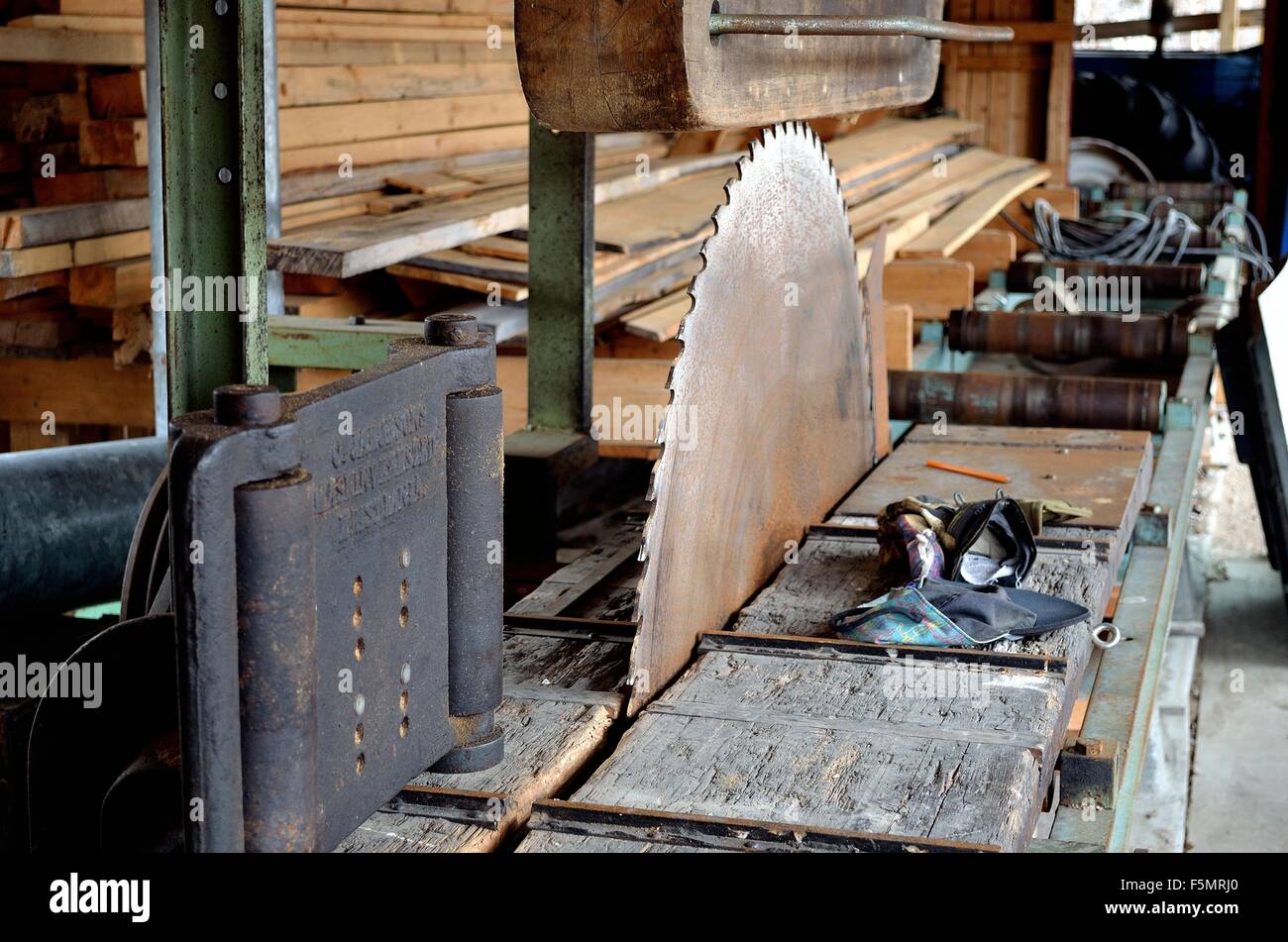 old massive sawmill blade with working gloves and tools Stock Photo - Alamy
