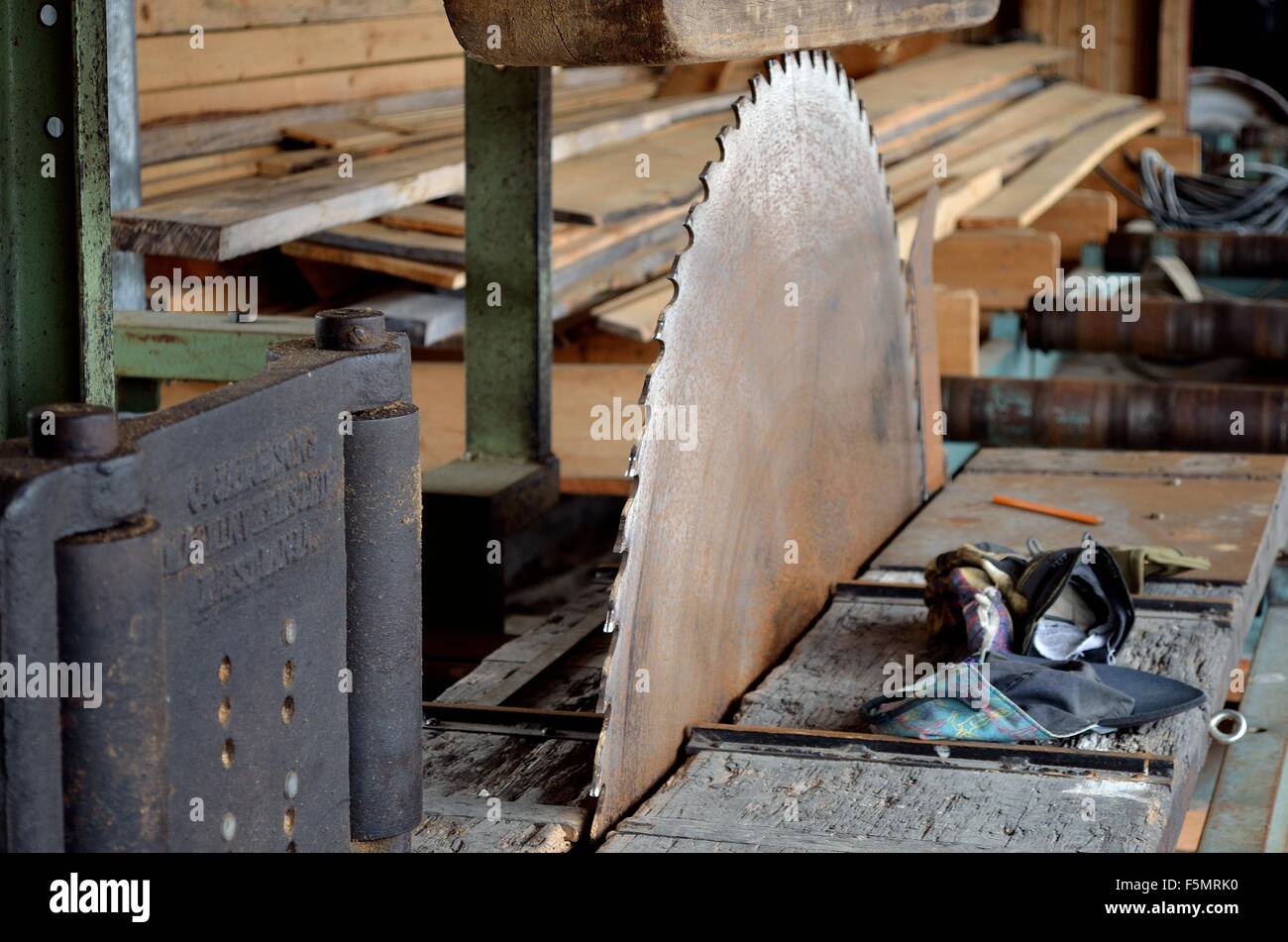 old massive sawmill blade with working gloves and tools Stock Photo - Alamy