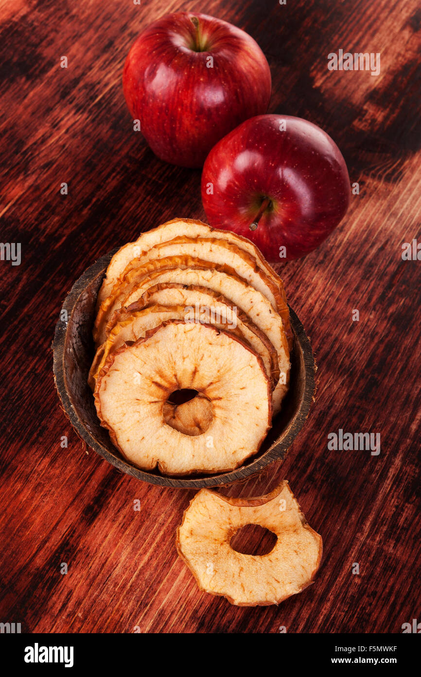 Dry and fresh apples on brown wooden table. Seasonal healthy snack ...