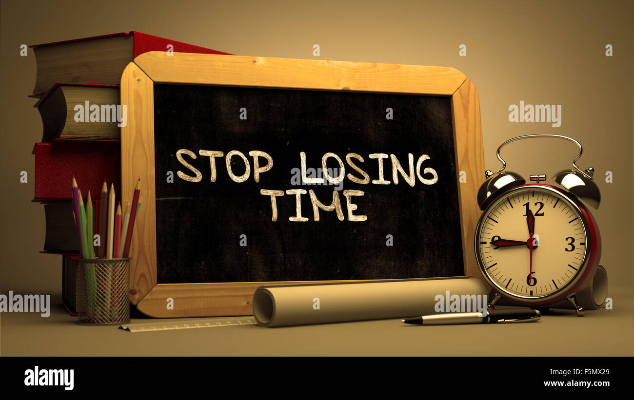 Handwritten Stop Losing Time on a Chalkboard Stock Photo - Alamy