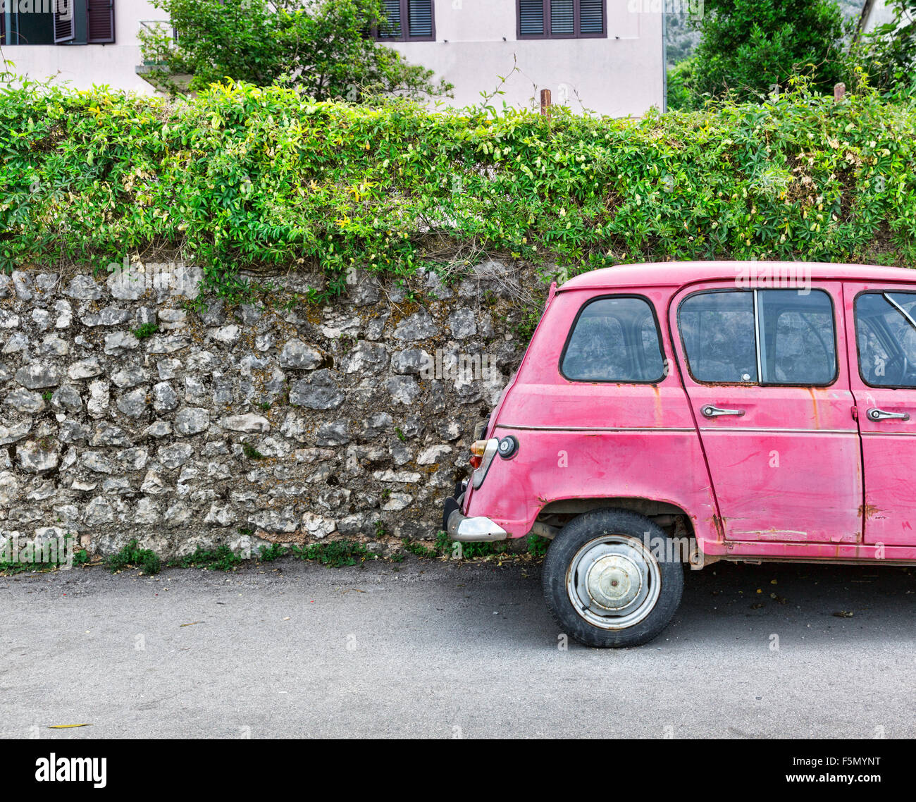 Old pink car near an old brick wall Stock Photo - Alamy