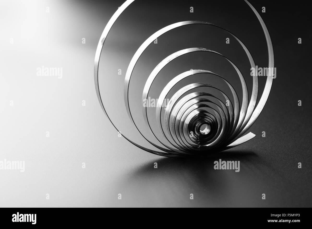 Abstract metallic spring on grey background Stock Photo - Alamy