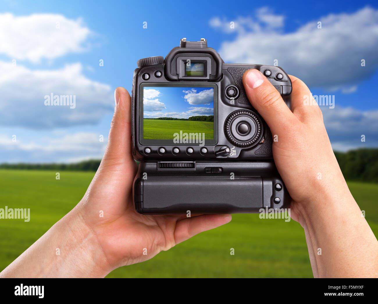 Hands holding digital camera and capturing rural landscape Stock Photo ...