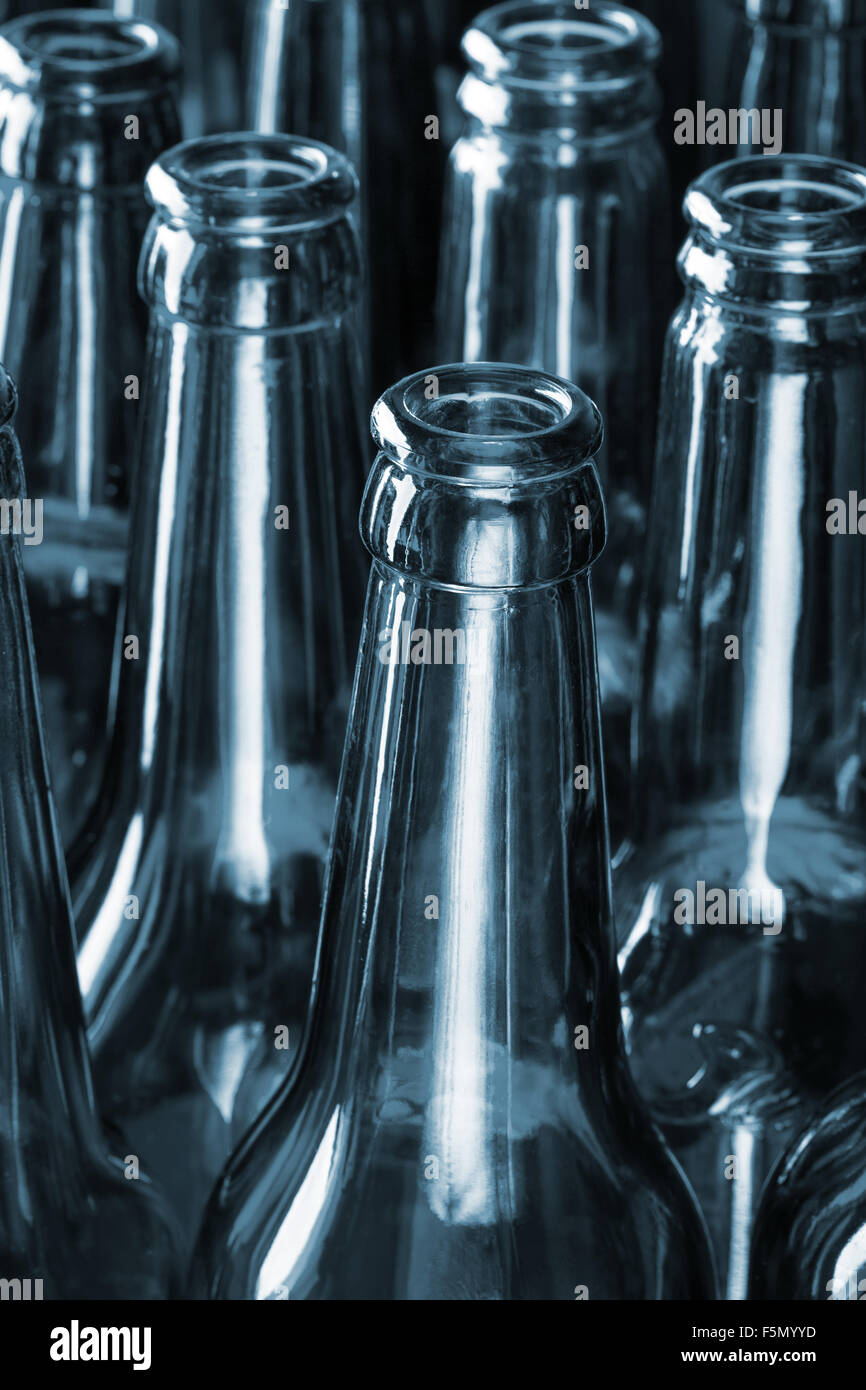 Many empty bottles in a row. Toned in blue Stock Photo - Alamy