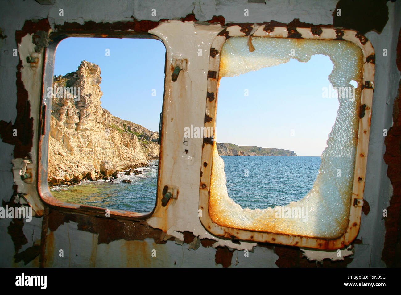 Shipwreck. Rusty abandoned cargo ship near mountain coast. Broken ...