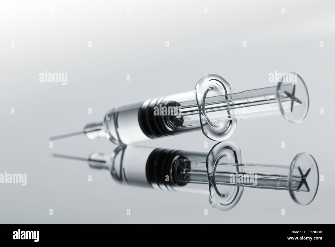 Medical syringe with injection on grey Stock Photo - Alamy