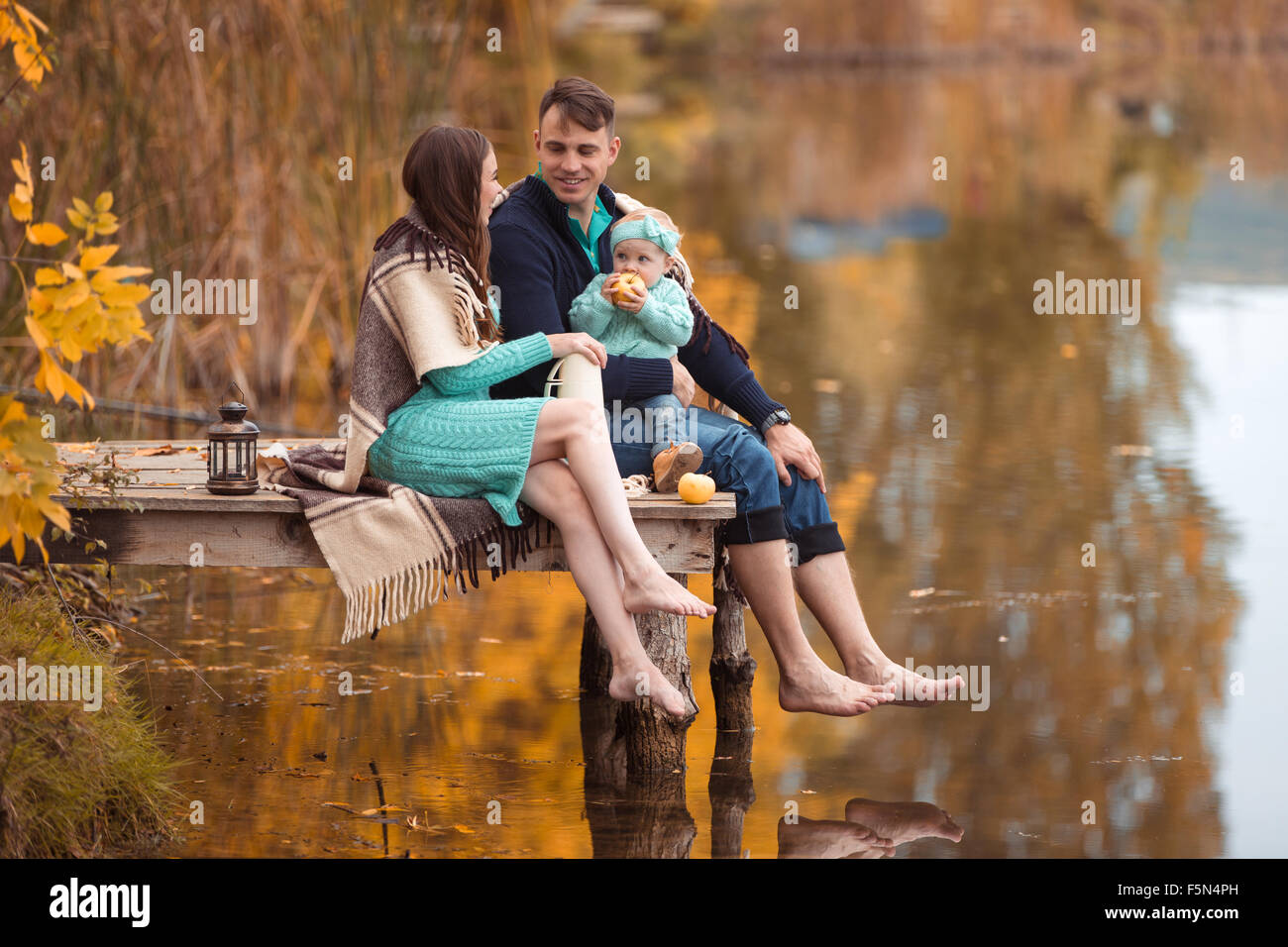 Family resting on the lake Stock Photo - Alamy