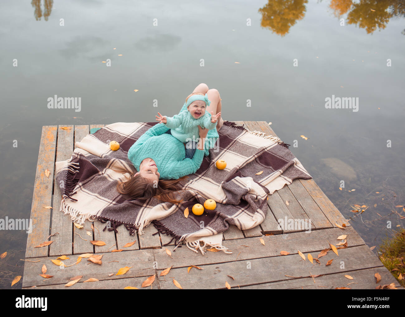 Family resting on the lake Stock Photo - Alamy