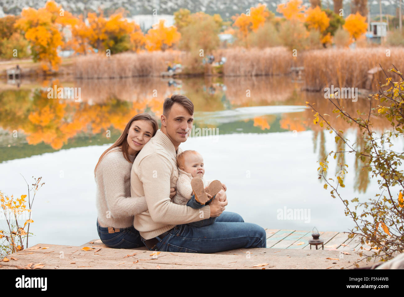 Family resting on the lake Stock Photo - Alamy